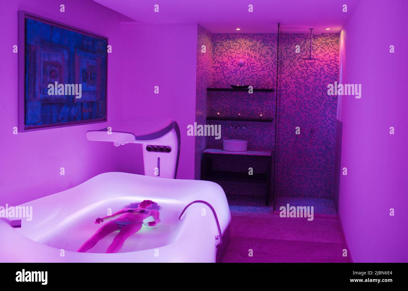 A woman floats in a chromotherapy tub during the Dream State treatment ...