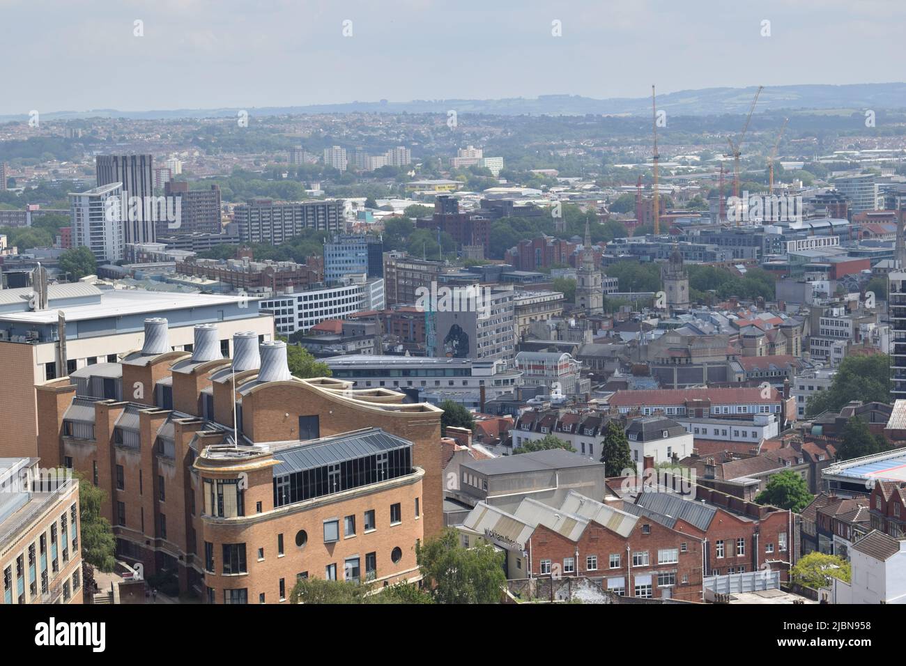 Aerial view of Bristol city during sunny day with sky and clouds. Many ...