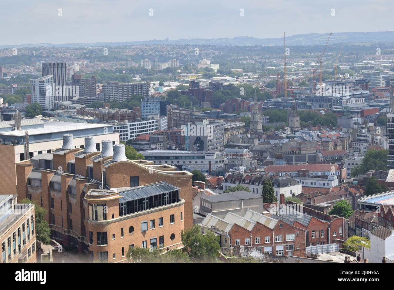 Aerial view of Bristol city during sunny day with sky and clouds. Many ...