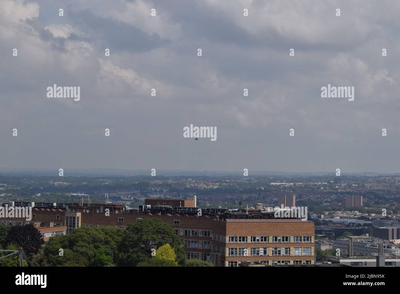 Aerial view of Bristol city during sunny day with sky and clouds. Many ...