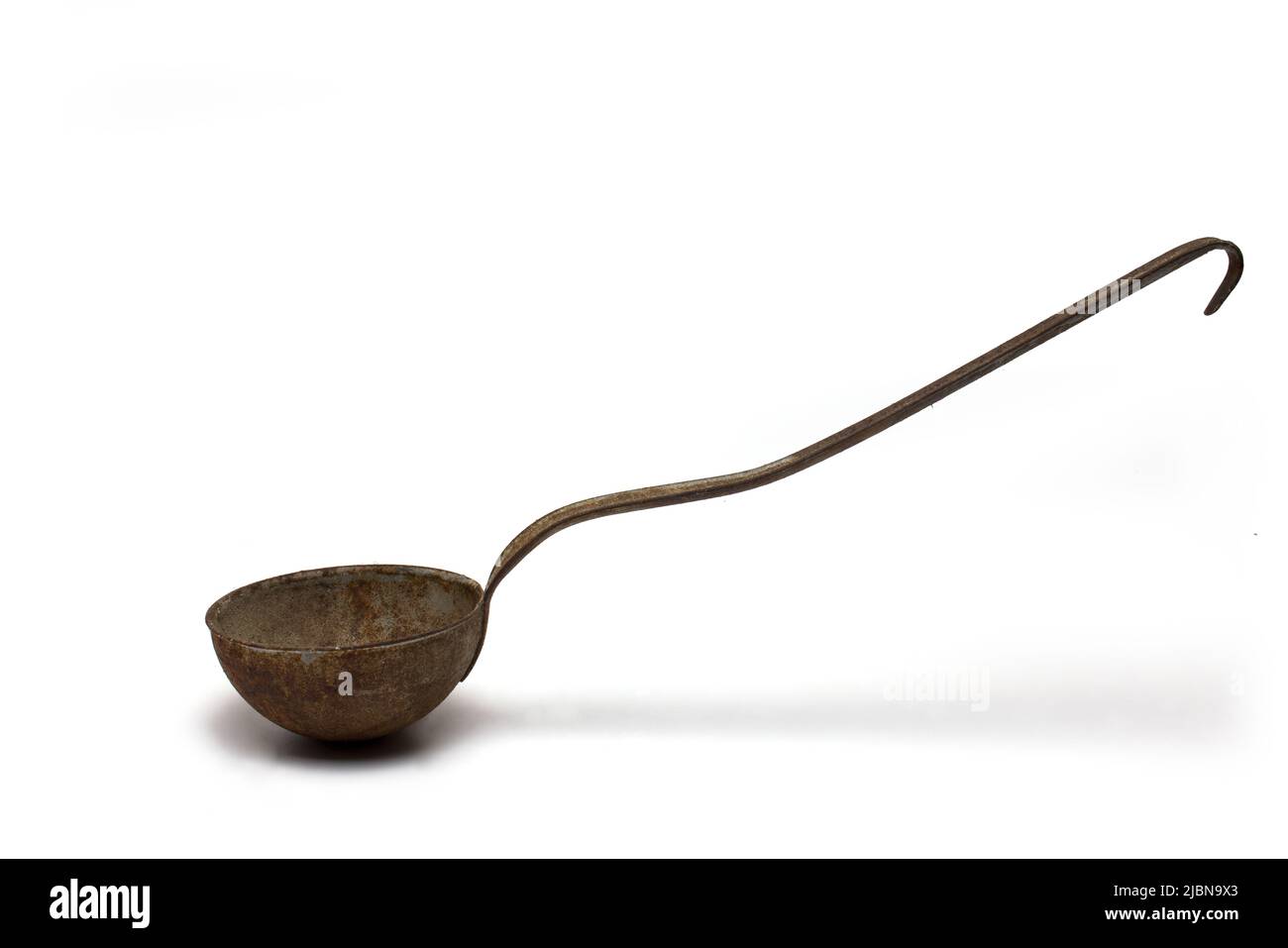 Close up side view profile of old rusted retro vintage soup ladle spoon ...