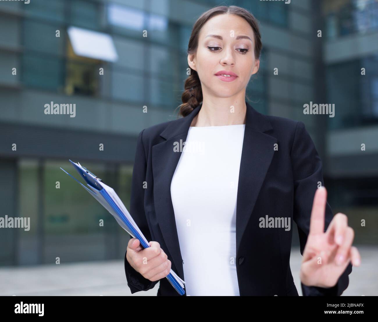 Adult woman manager is asking companion to wait Stock Photo - Alamy