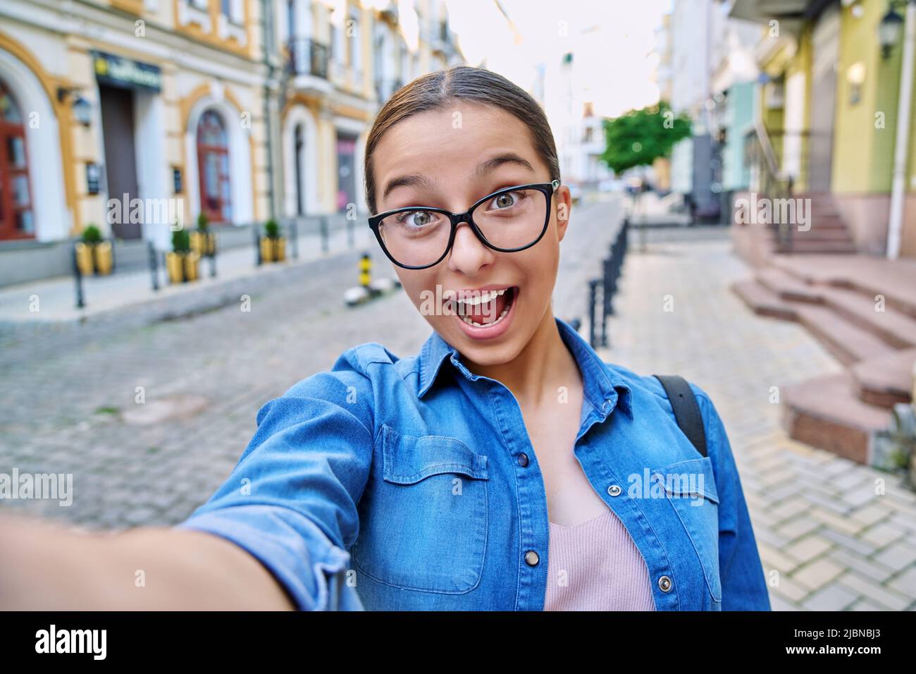 Selfie portrait of beautiful cheerful teenage girl, outdoor on city ...