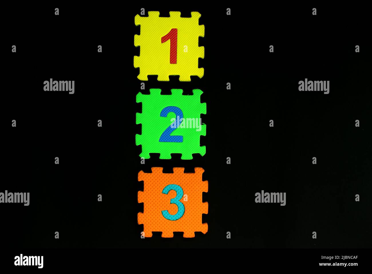 Colorful number puzzle isolated on black background. Number learning ...