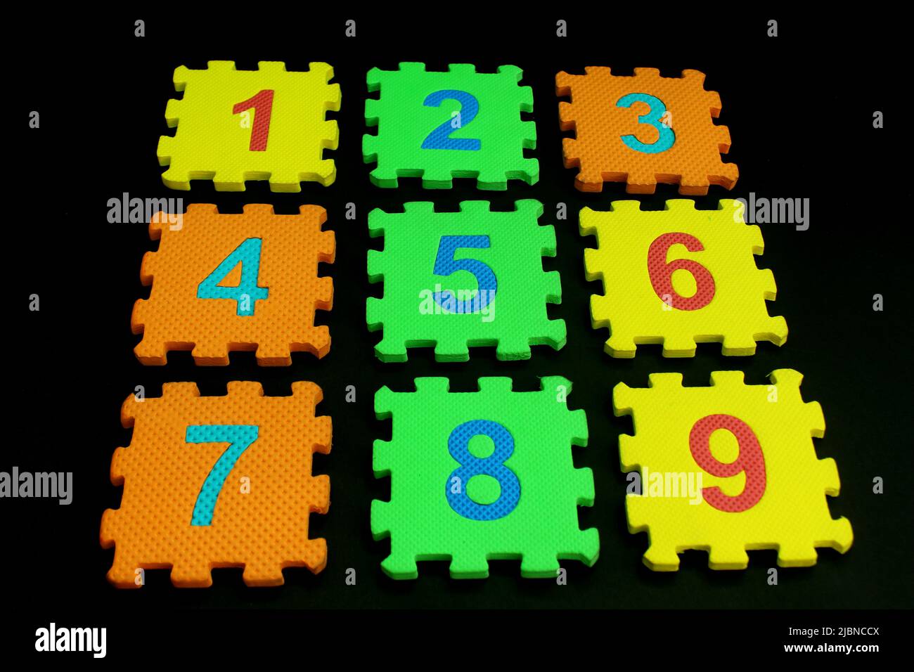 Colorful number puzzle isolated on black background. Number learning ...