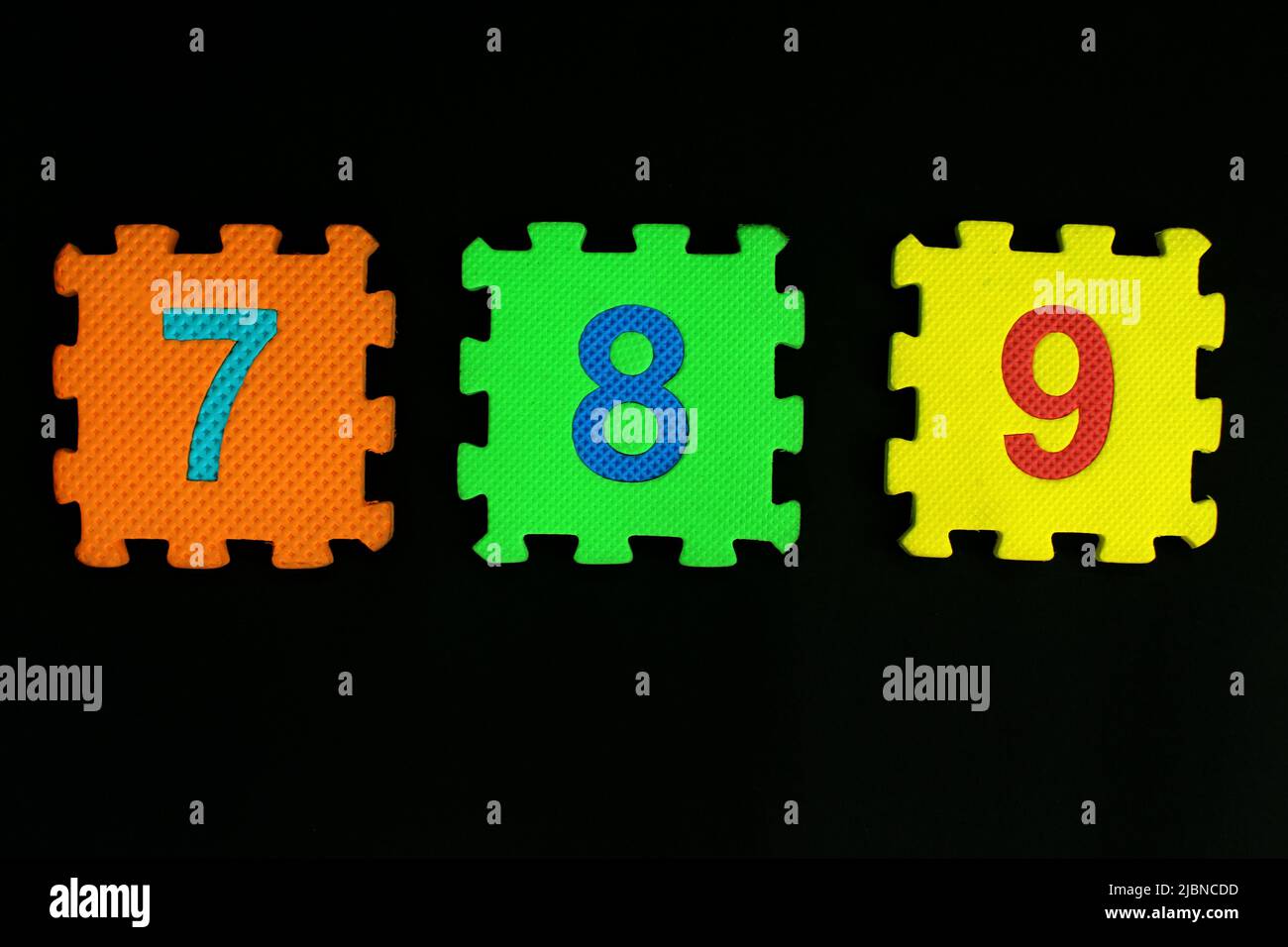 Colorful number puzzle isolated on black background. Number learning ...