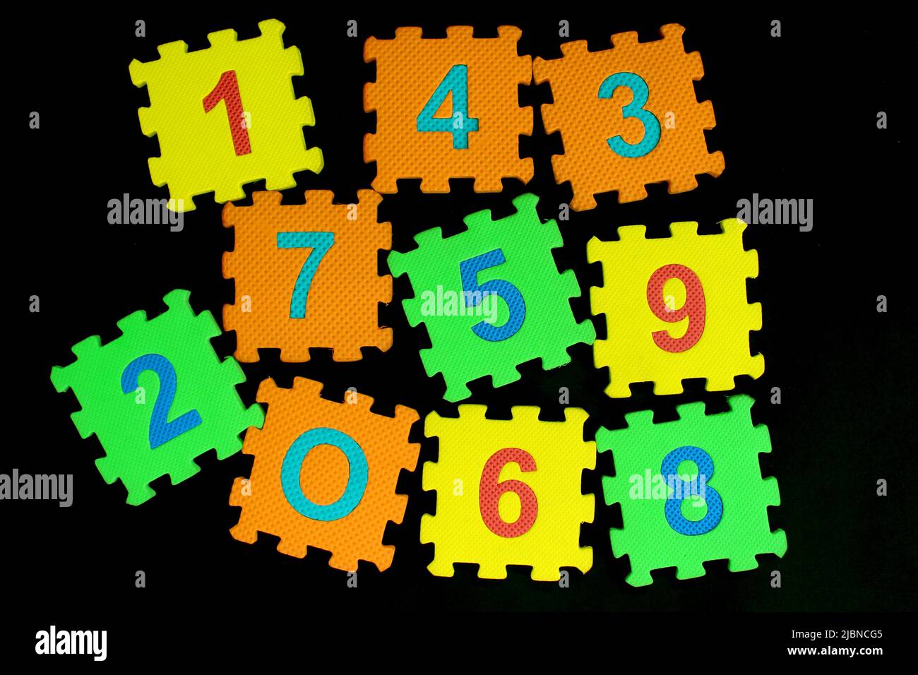 Colorful number puzzle isolated on black background. Number learning ...