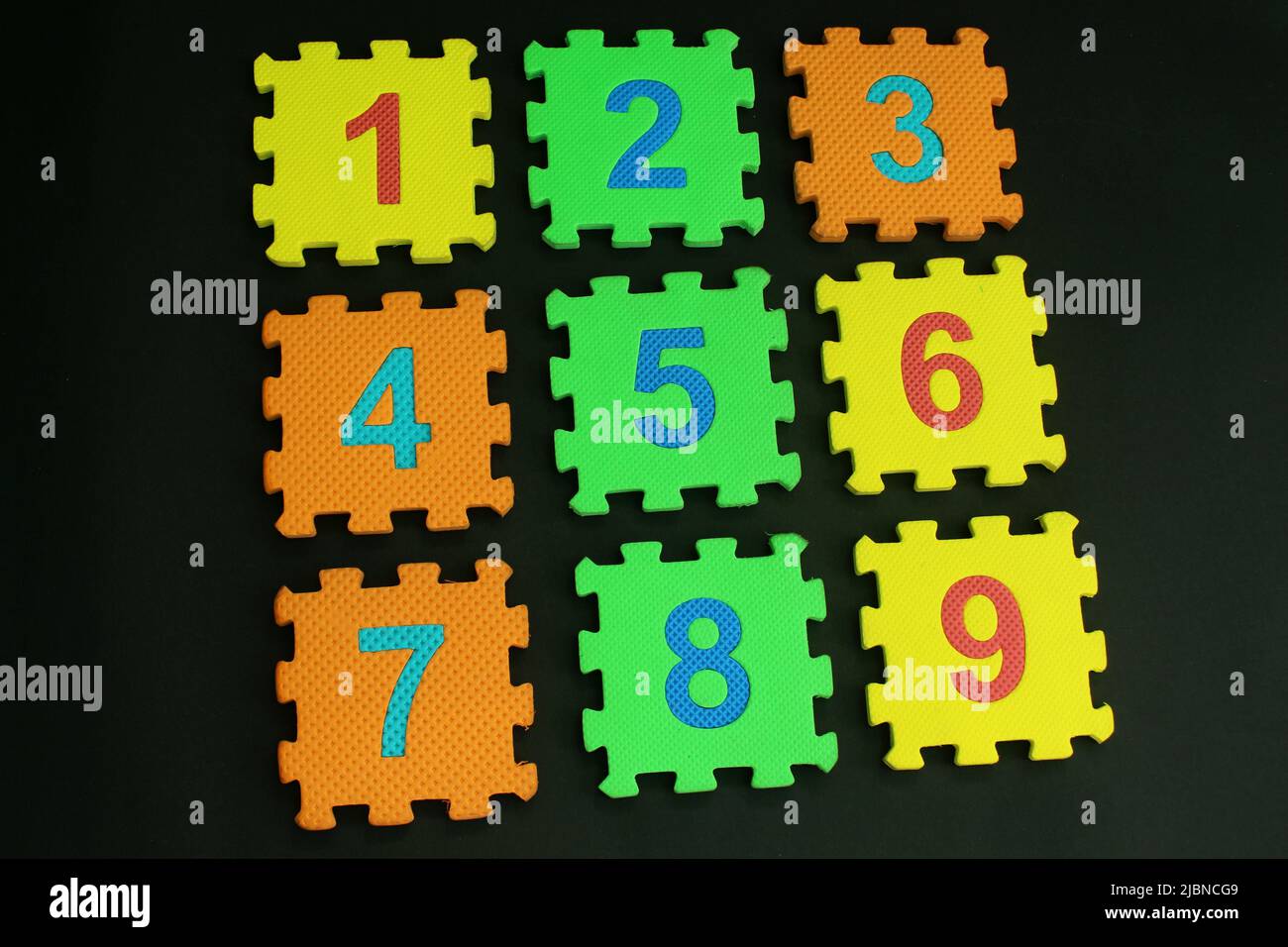 Colorful number puzzle isolated on black background. Number learning ...