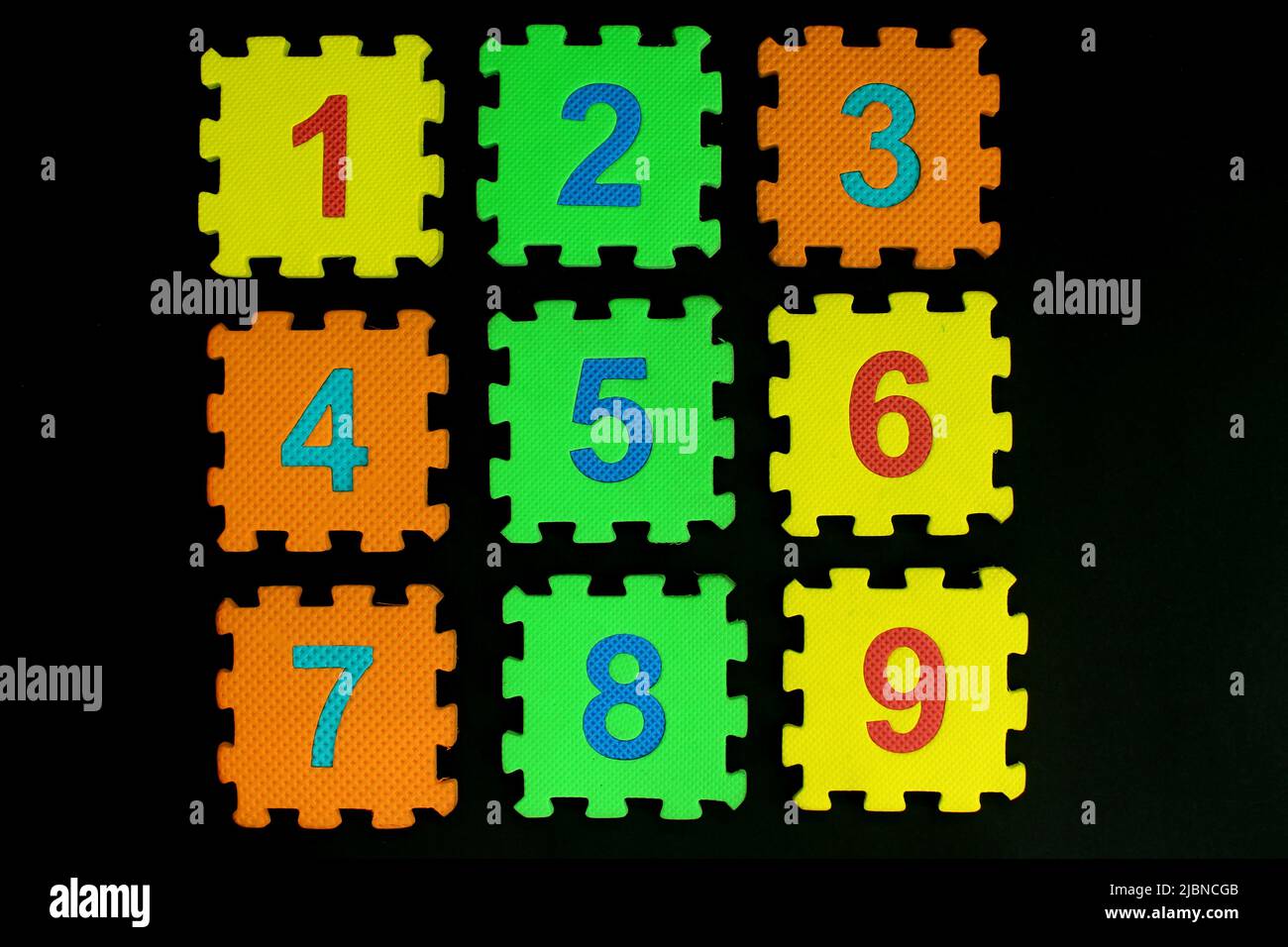 Colorful number puzzle isolated on black background. Number learning ...