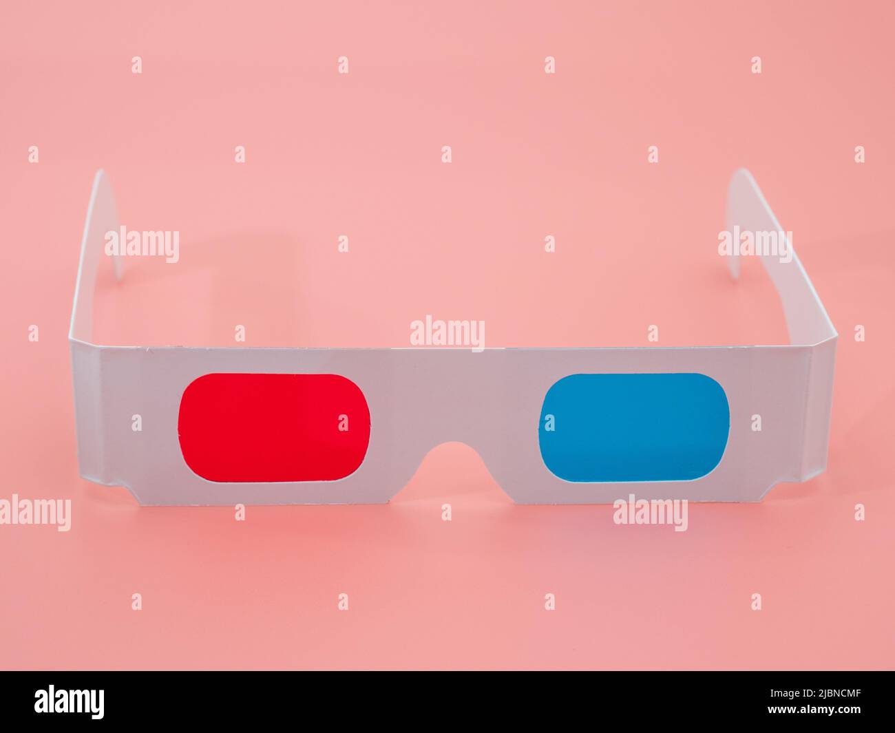 Red And Blue Paper Glasses For Viewing 3d Movies And Images Isolated On A Pink Background Stock