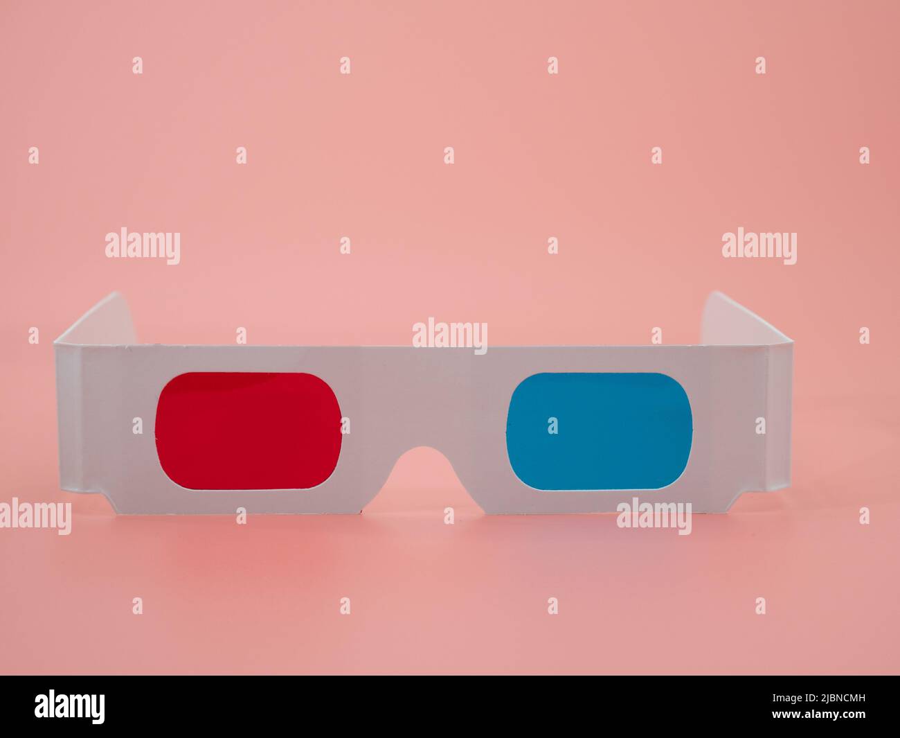 Red And Blue Paper Glasses For Viewing 3d Movies And Images Isolated On A Pink Background Stock