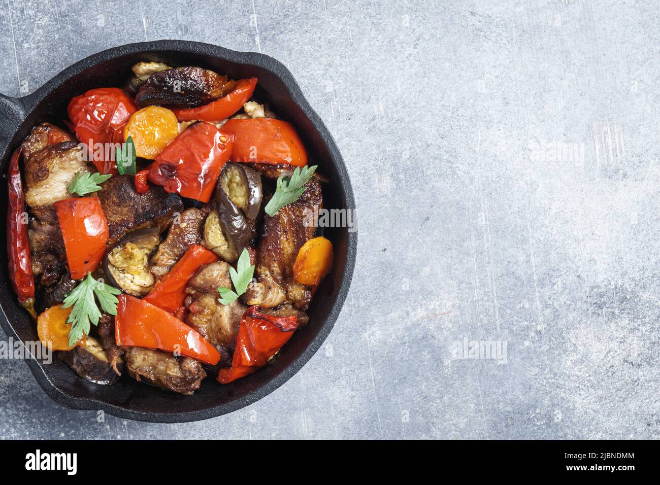 Beef roast with sauteed bell pepper and other vegetables on pan, top ...