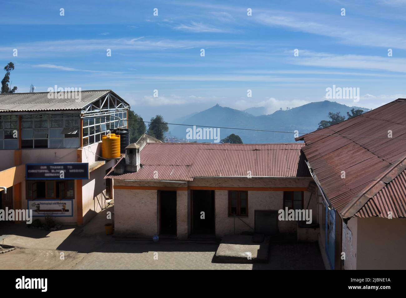 A complex of rural buildings against the background of a mountain ...