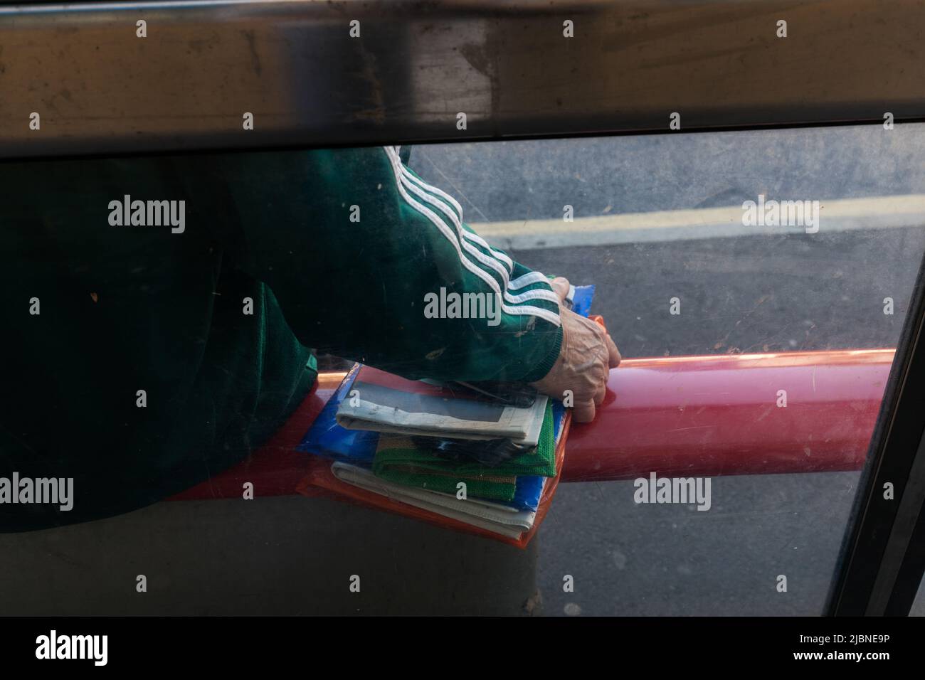 Waiting at a bus stop with newspapers Stock Photo - Alamy