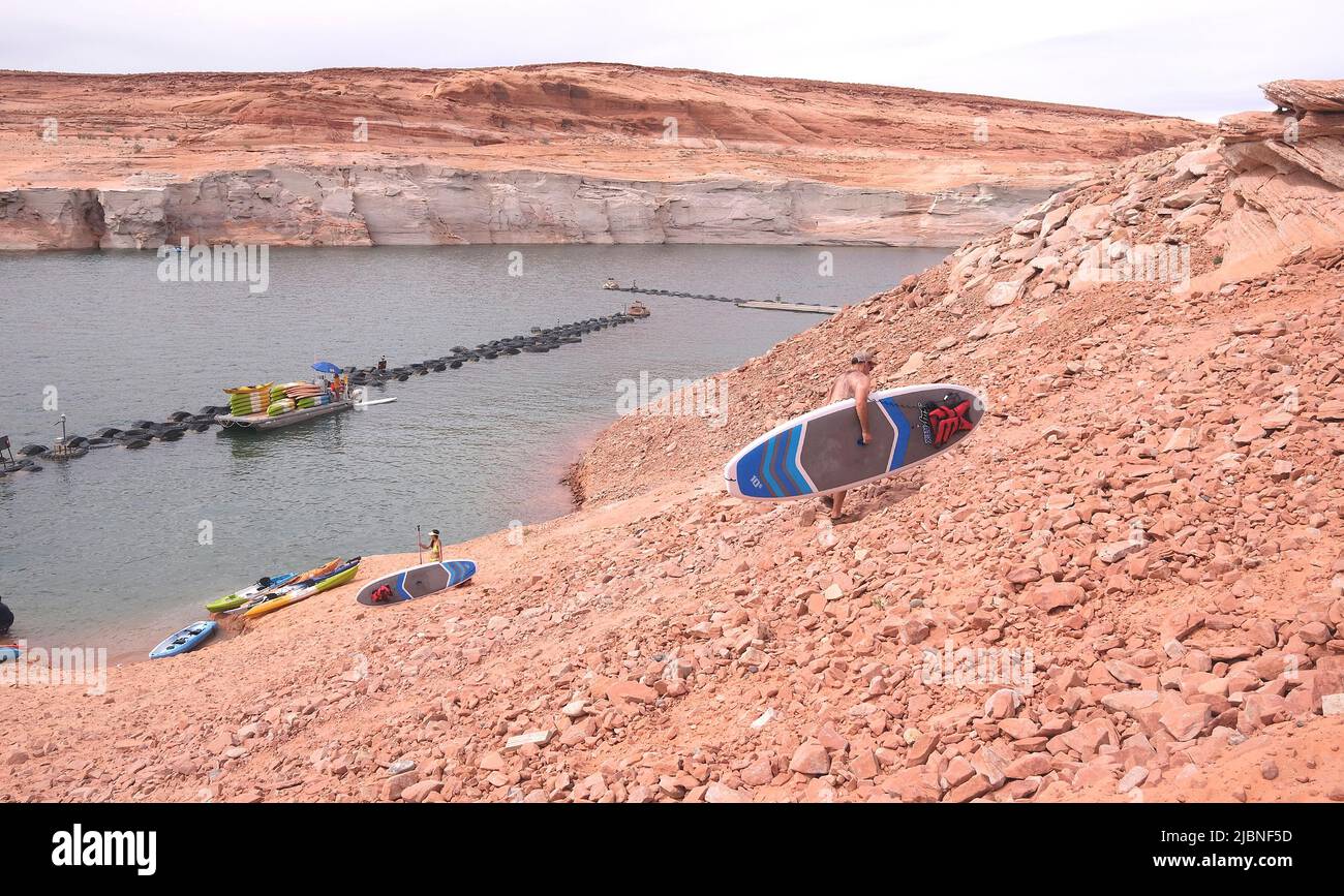 Page, Arizona, USA. 4th June, 2022. Paddleboarders carry boards up to ...