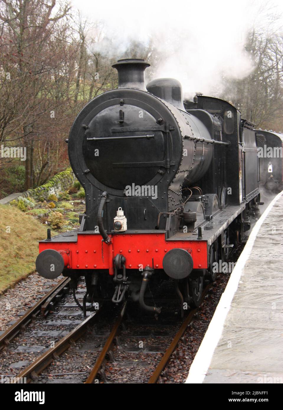 A Vintage Steam Engine Pulling Away from it's Carriages Stock Photo - Alamy