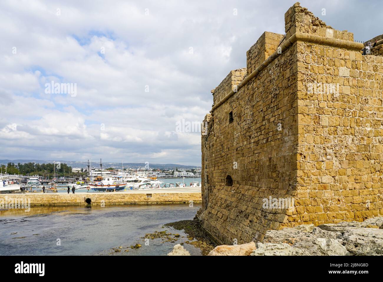 Ancient Paphos Castle in Cyprus and a pier made of large stones against ...