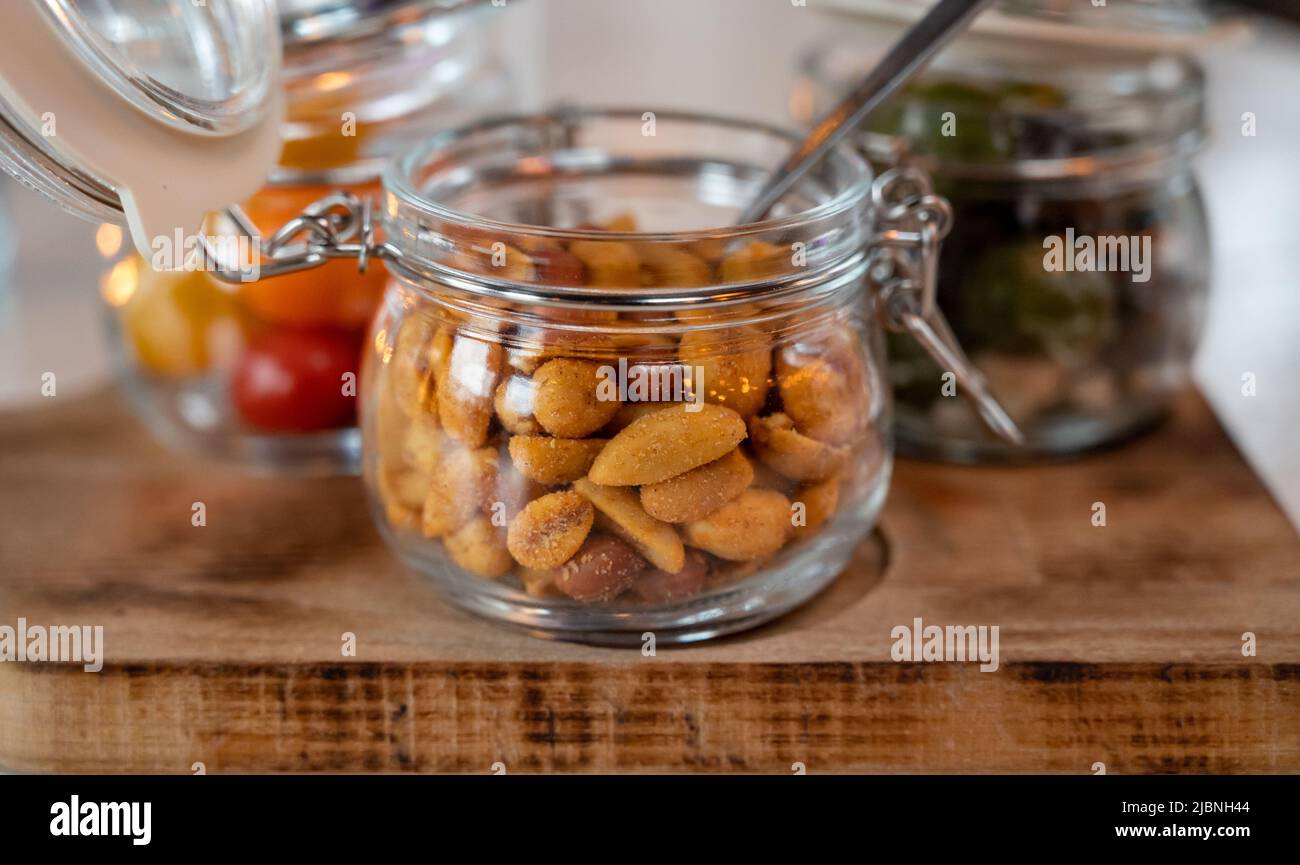 Glass jars with healthy party snacks served in bar, tasty appetisers ...