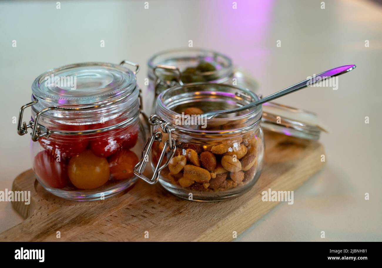 Glass jars with healthy party snacks served in bar, tasty appetisers ...