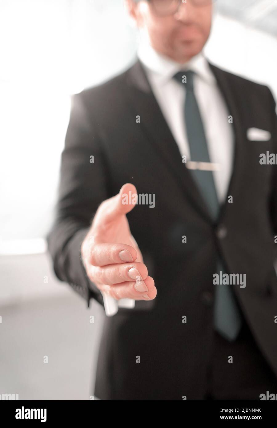 Businessman holding hand out handshake hi-res stock photography and ...