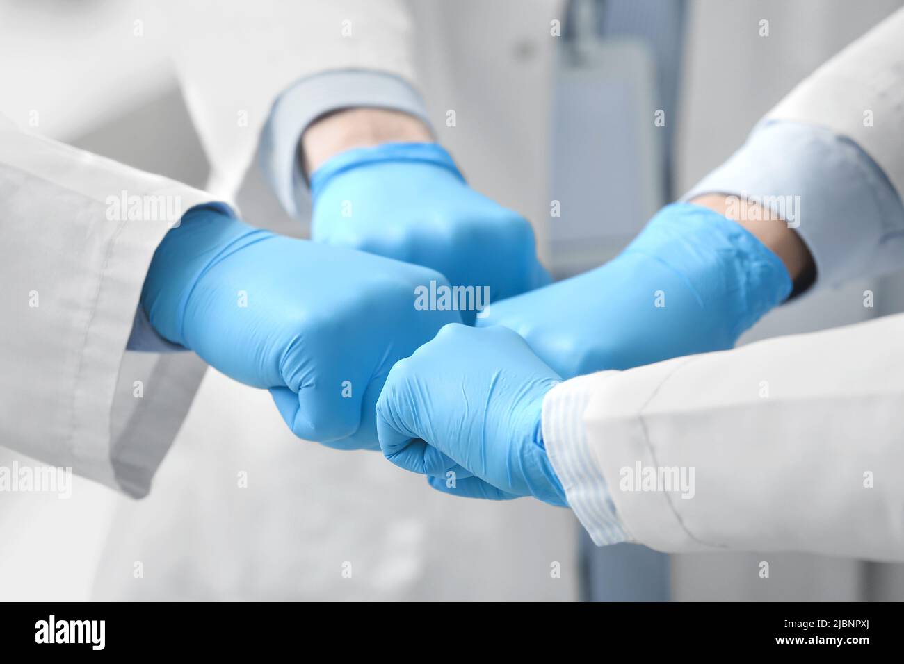 Group of doctors putting hands together in clinic, closeup Stock Photo ...