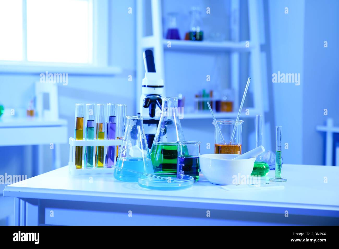 Different chemical glassware on table in medical laboratory Stock Photo ...