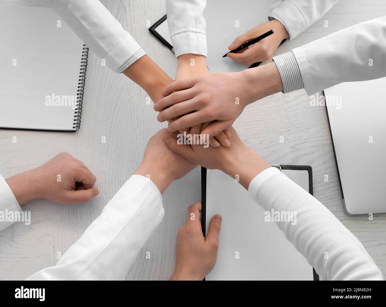 Group of doctors putting hands together in clinic, top view Stock Photo ...
