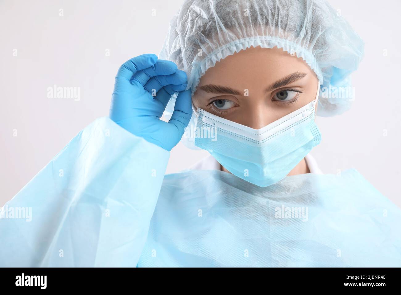 Female surgeon on light background Stock Photo - Alamy