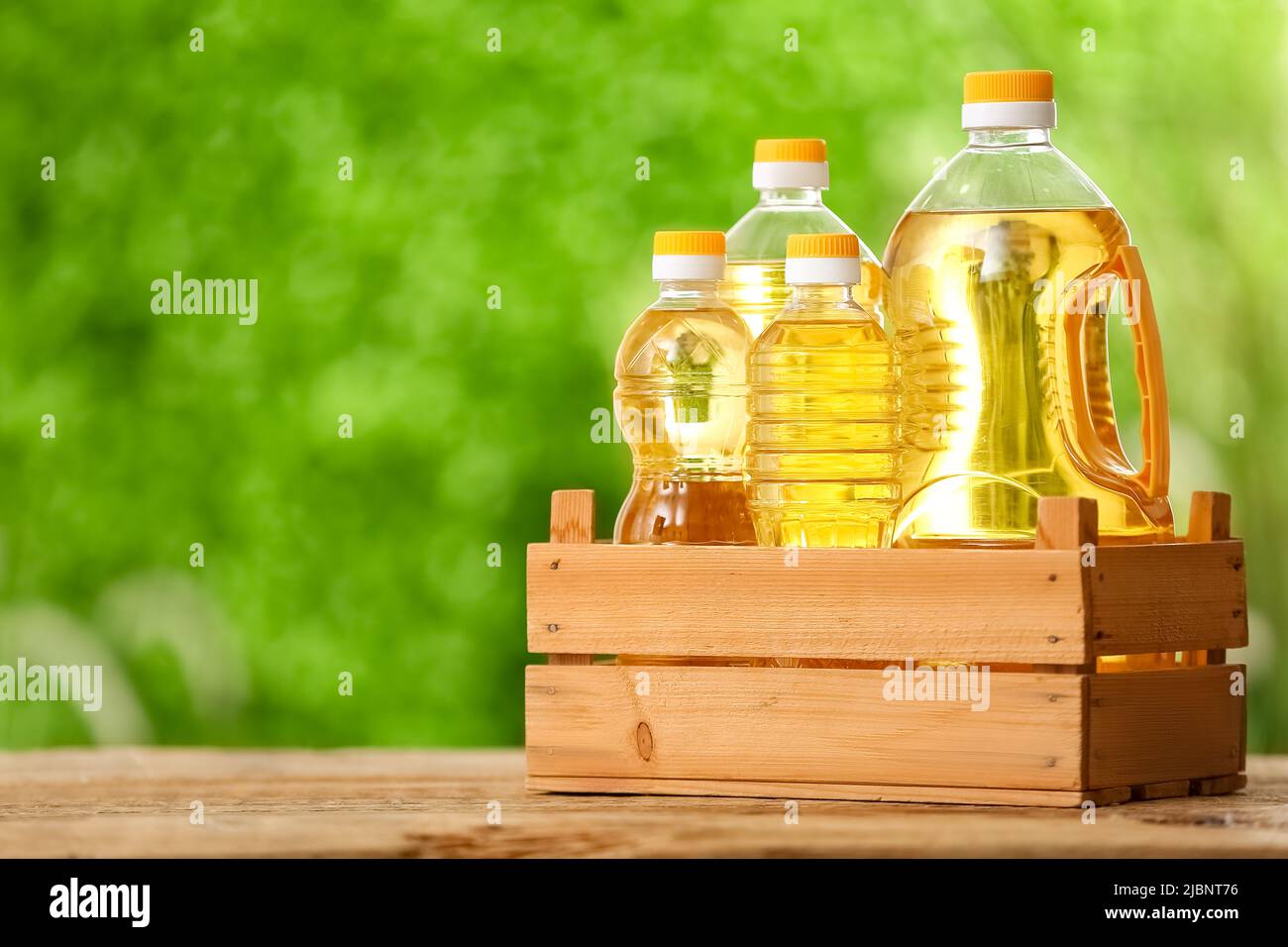 Box with bottles of sunflower oil on table outdoors Stock Photo - Alamy