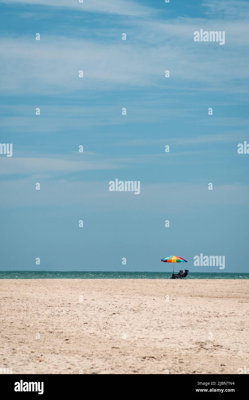 Colorful beach umbrella on tropical beach with copy space. Portrait ...