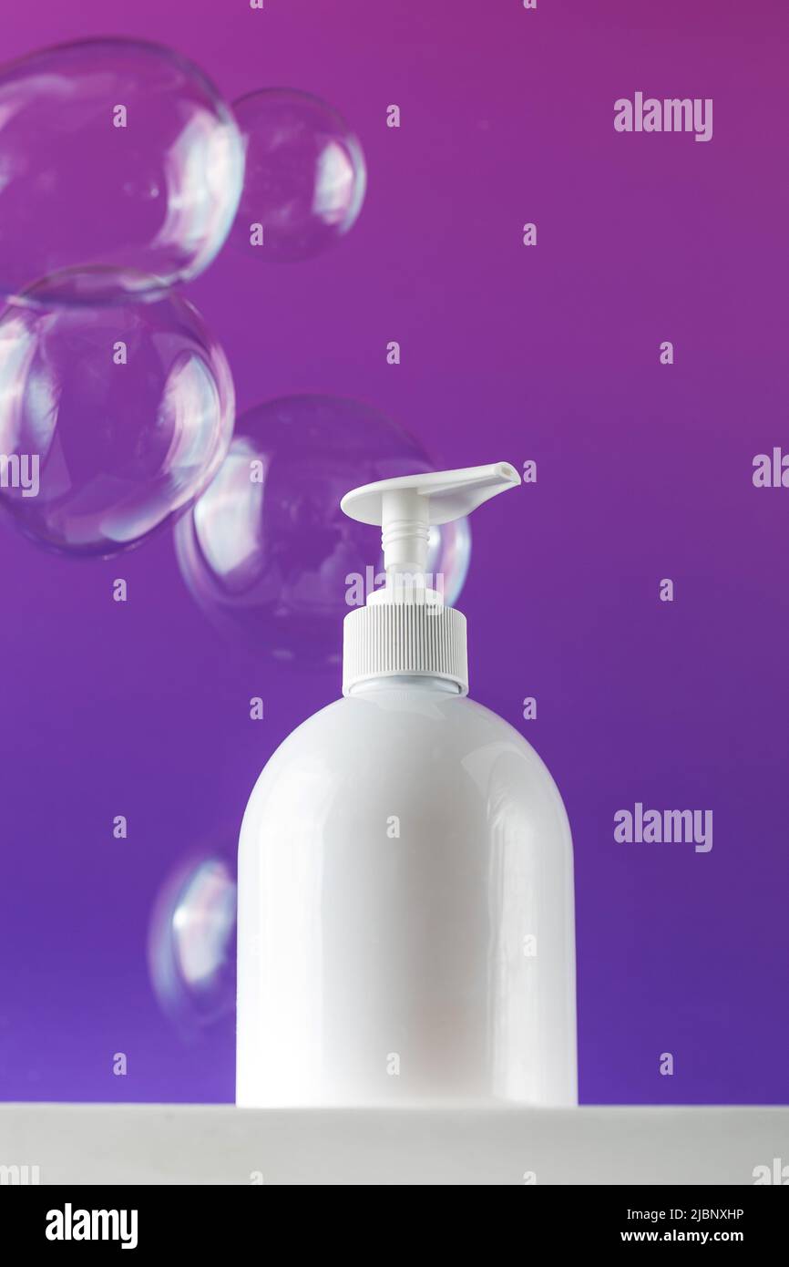 Mockup of a white dispenser with a cosmetic product on a pedestal on a ...