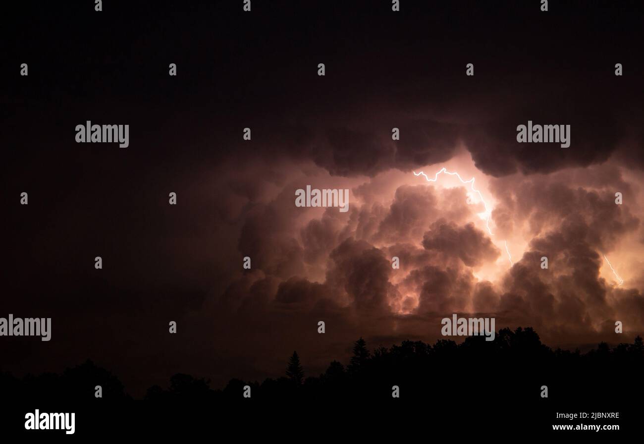 Lightning in the sky during a storm at night Stock Photo - Alamy