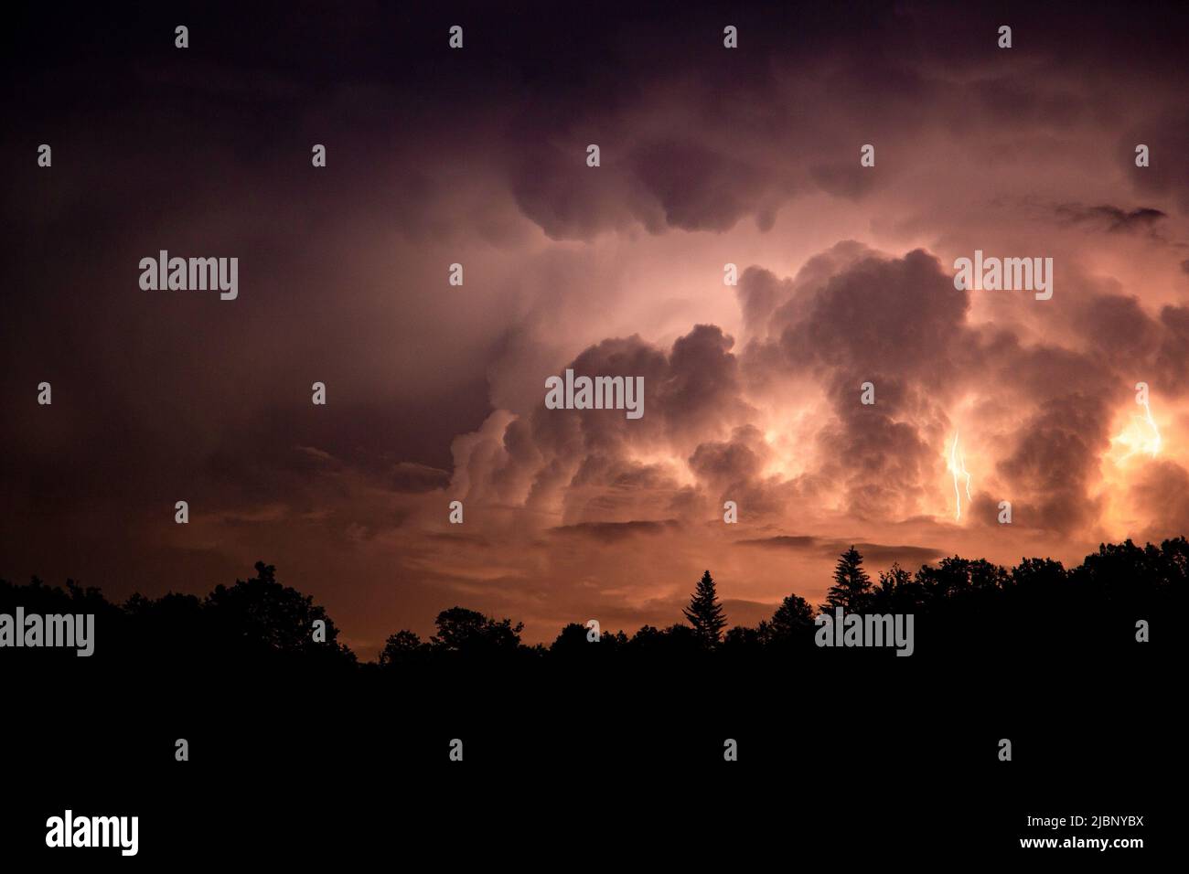 Lightning in the sky during a storm at night Stock Photo - Alamy