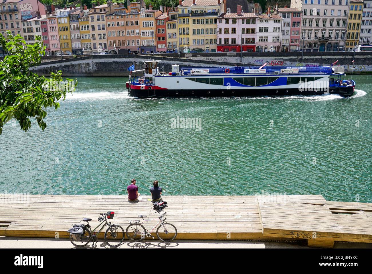 A barge sails on the river Saône at foot of Fourvière Hill, Lyon, Rhône ...