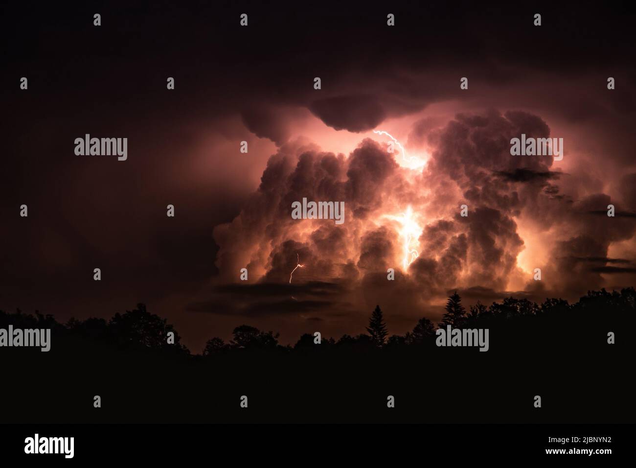 Lightning in the sky during a storm at night Stock Photo - Alamy