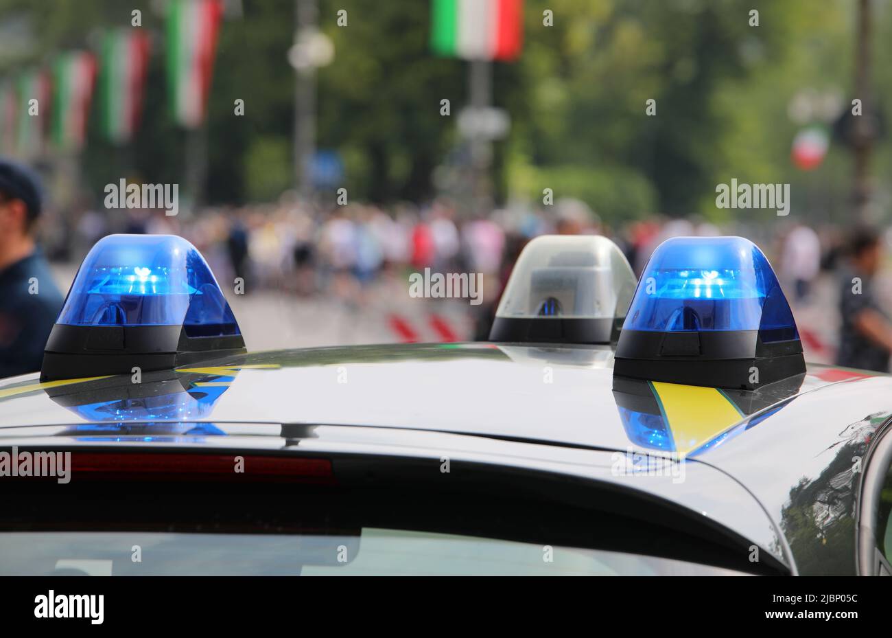two blue lights sirens of police car and unrecognizable people during ...