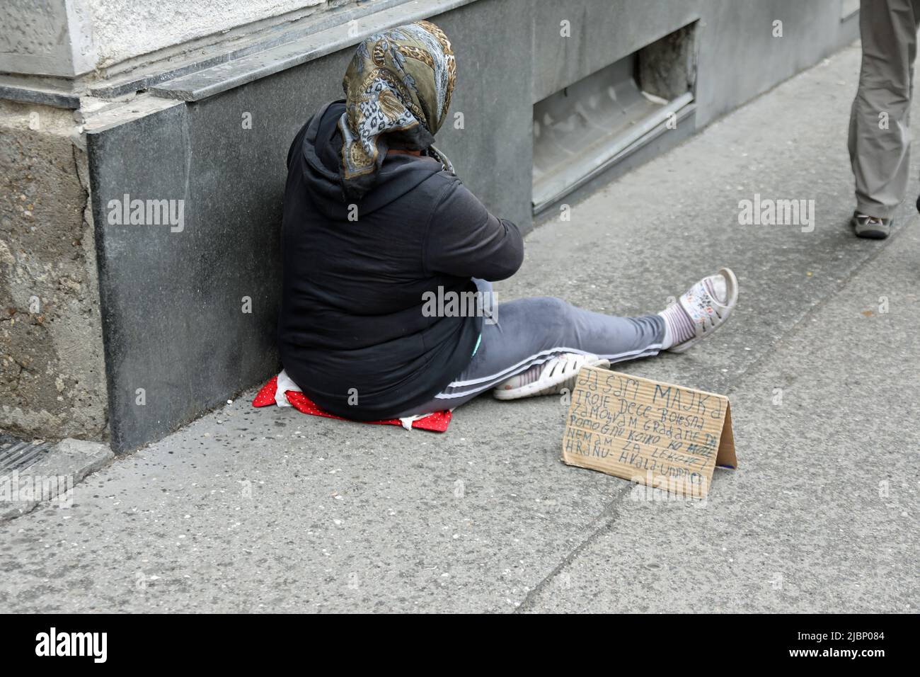 Woman begging on the street in Belgrade Stock Photo - Alamy