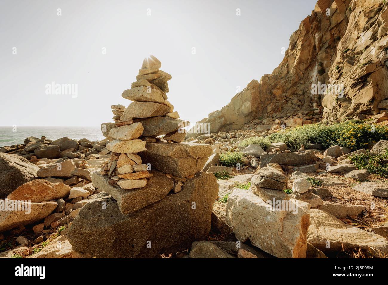 Stone pyramids on the beach at sunset, California. Balance, tranquility ...