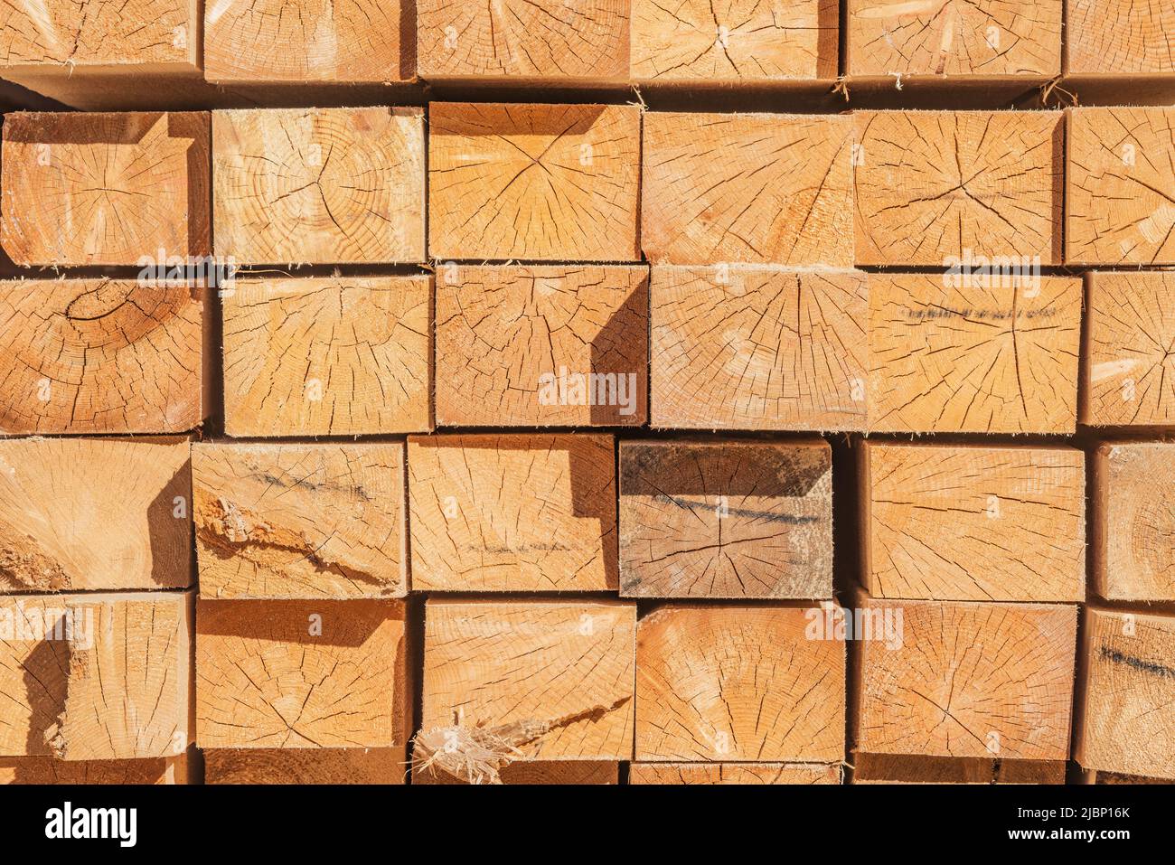 Pine wood timber stack of natural rough wooden boards on building site ...