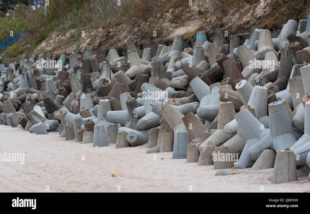 Concrete breakwaters made of tetrapod blocks. Breakwater on the beach ...
