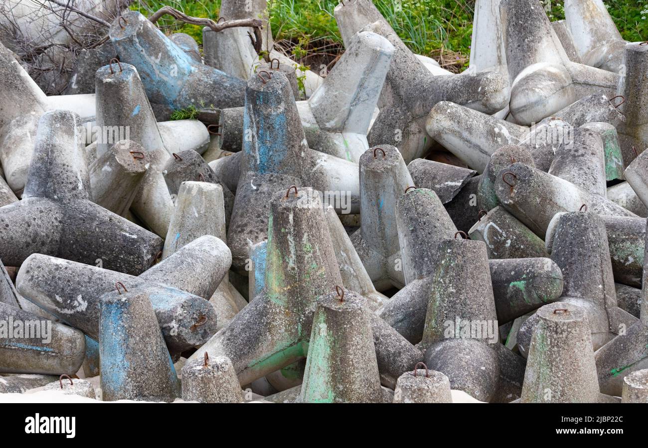 Concrete breakwaters made of tetrapod blocks. Breakwater on the beach ...