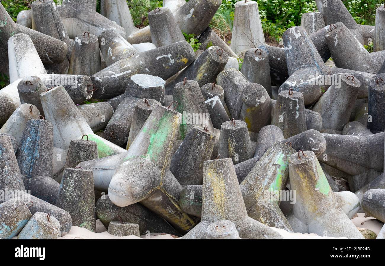 Concrete breakwaters made of tetrapod blocks. Breakwater on the beach ...