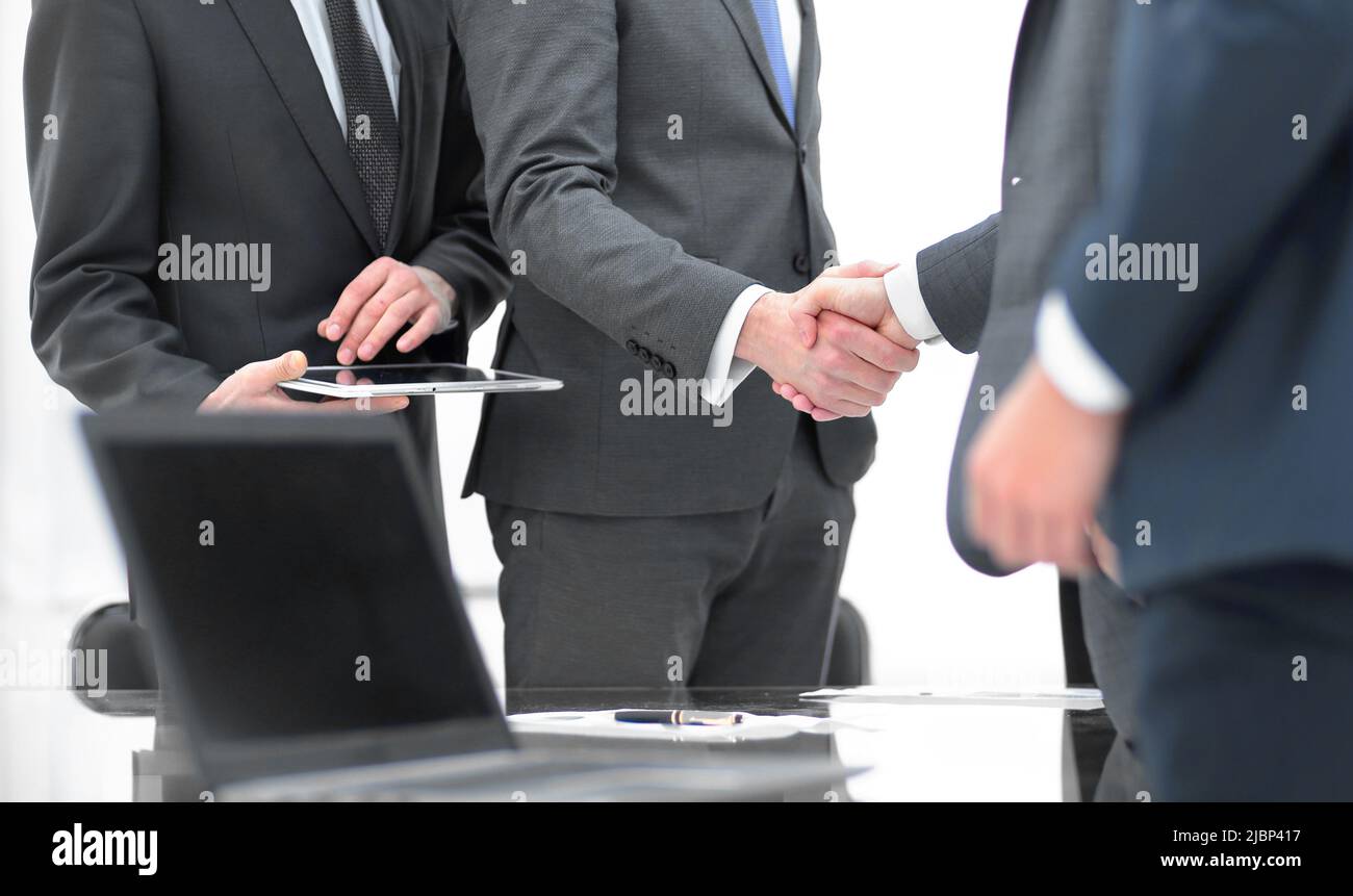 Business partners handshaking with their colleagues Stock Photo - Alamy