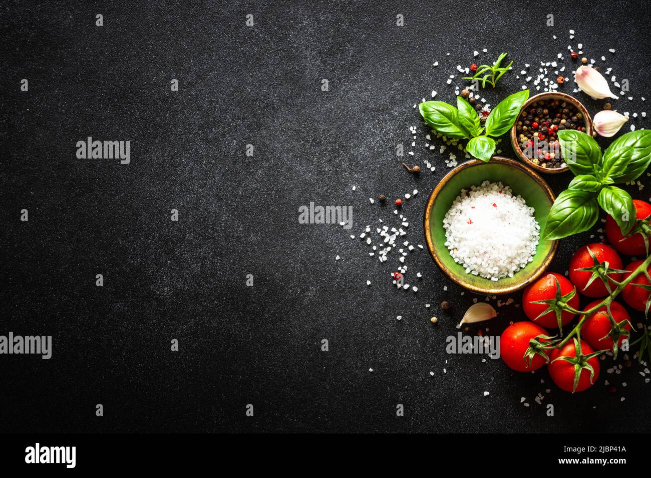 Food cooking background on black stone table Stock Photo - Alamy
