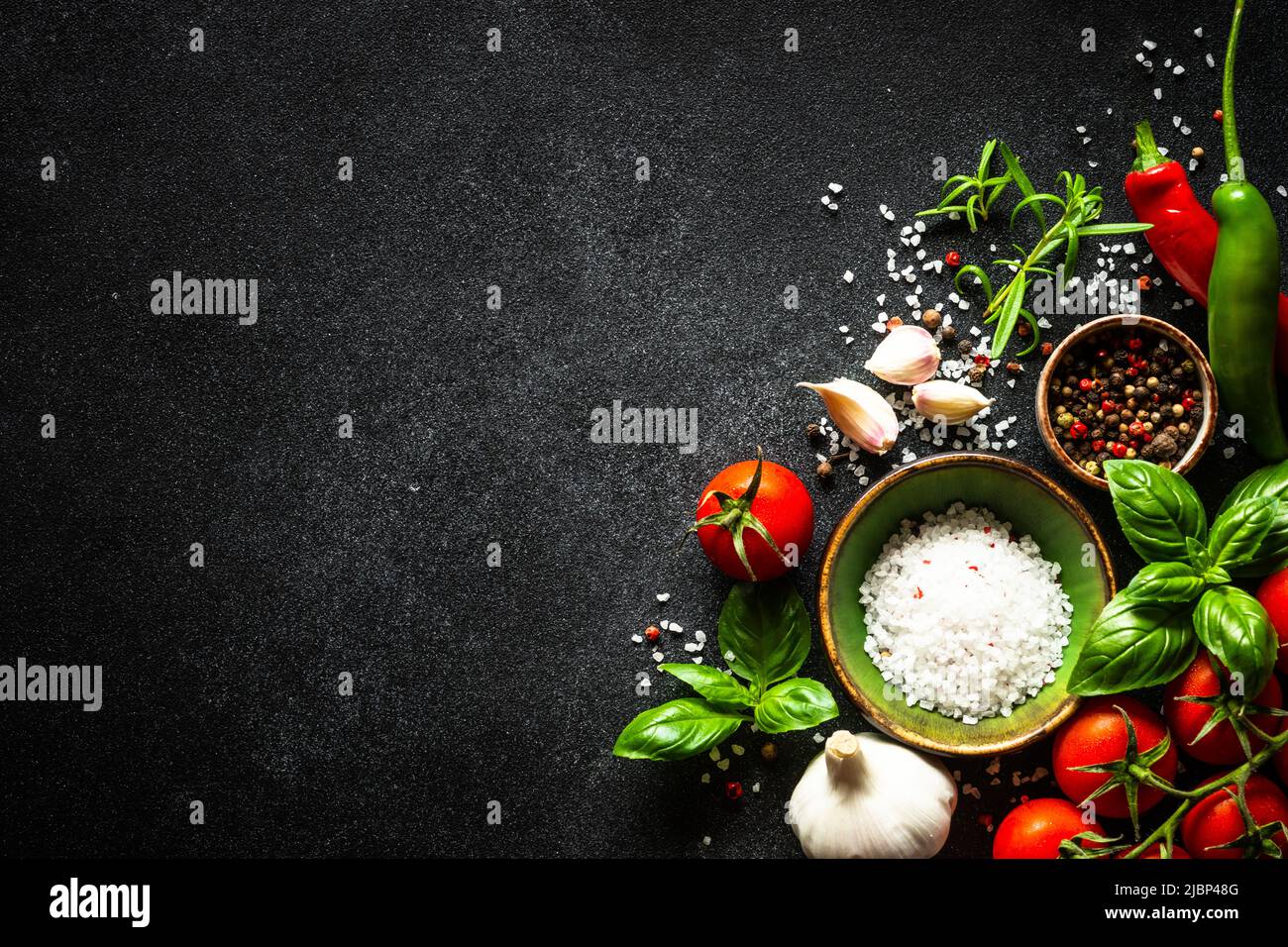 Food cooking background on black stone table Stock Photo - Alamy