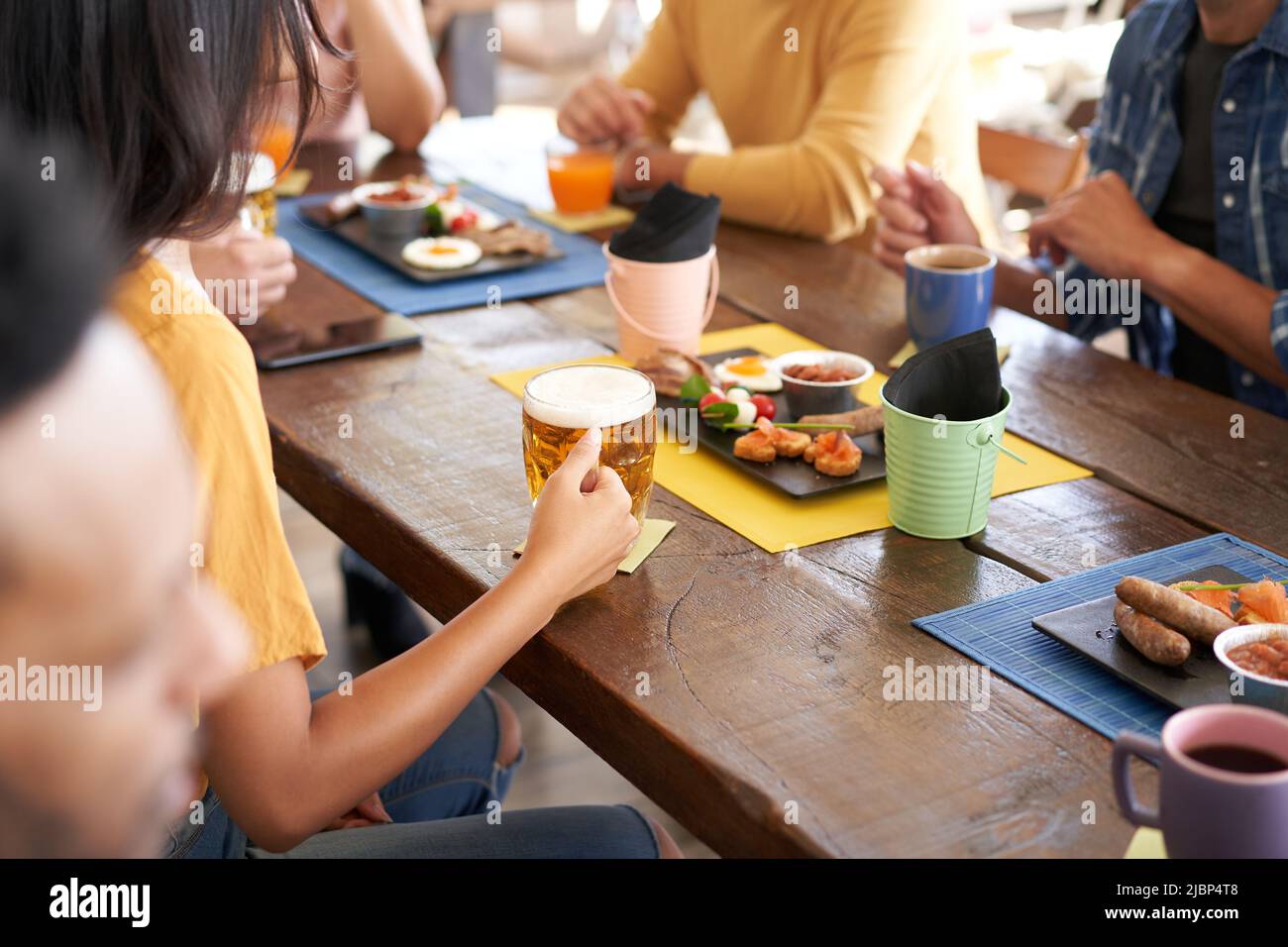Friends in the terrace bar Pub. Drinking beer, talking, having fun ...