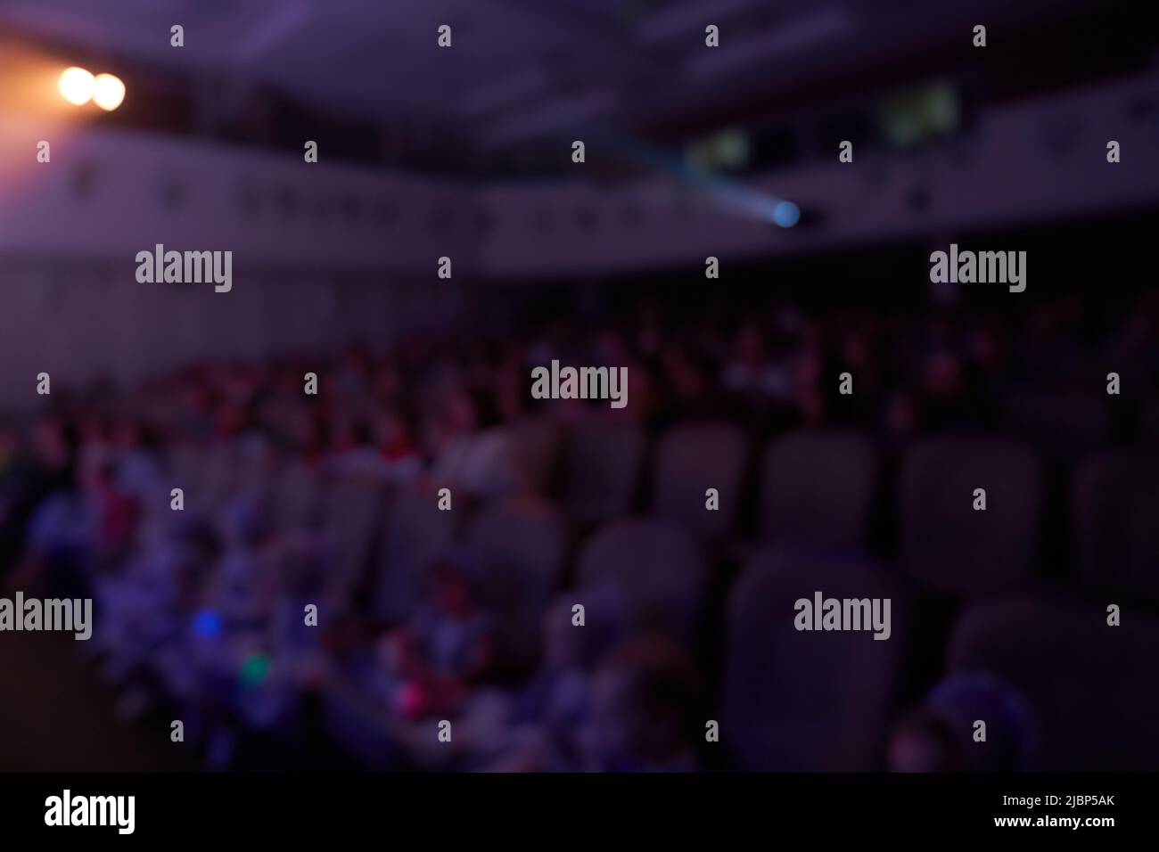 Event hall with chairs on a blurry background. The audience of a music ...