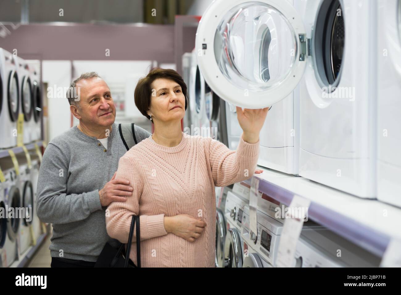Mature woman washing machine hi-res stock photography and images - Alamy