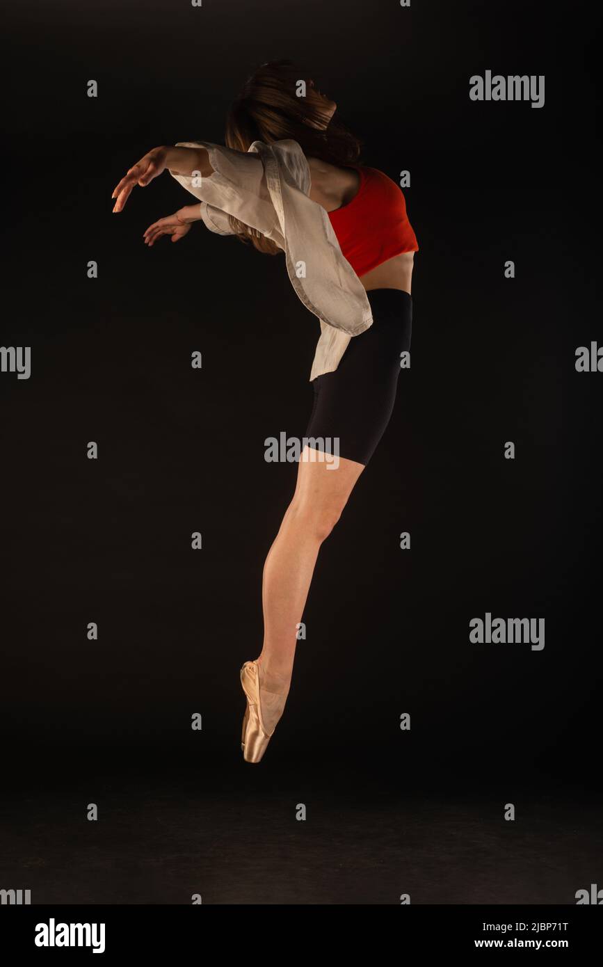 Balleria is having a perfect ballet jump posture in the air while ...