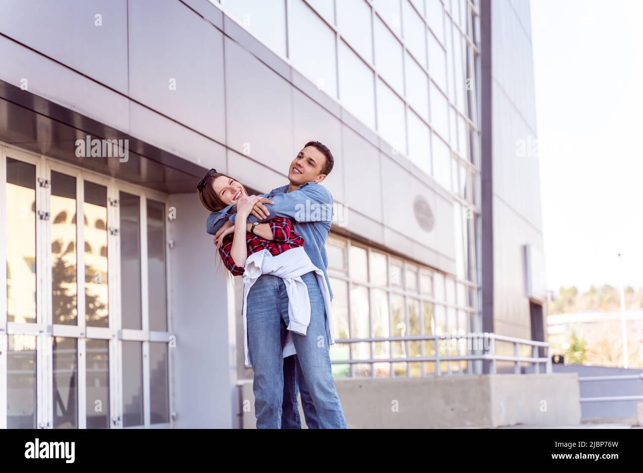 Woman and hugging man outside building hi-res stock photography and ...